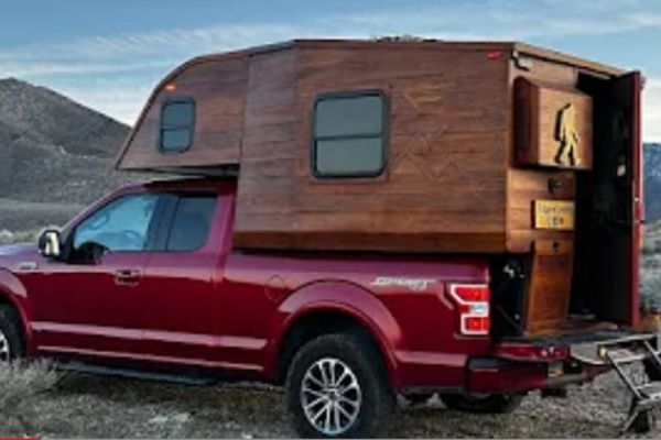 This gorgeous DIY truck camper is made from fence pickets